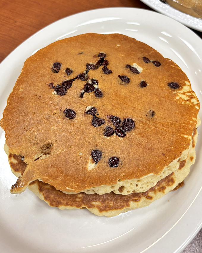 Pancakes that could double as pillows, studded with blueberries like edible constellations. Breakfast of champions and night-shift workers alike.