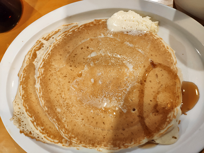 Pancakes so perfectly golden they belong in Fort Knox. That melting pat of butter creating a river of deliciousness that demands maple syrup's company.