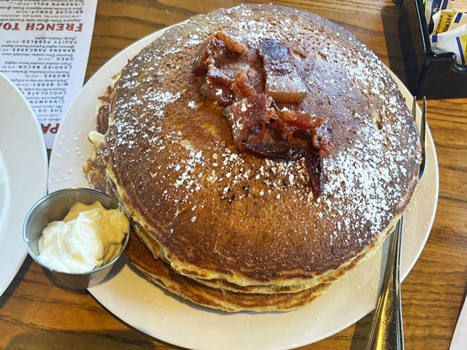 Pancakes so fluffy they could float away if not anchored by that glorious crown of candied bacon. Whoever said "less is more" clearly never had these.