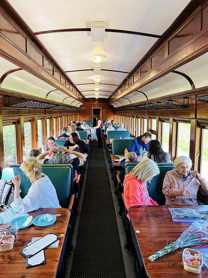 All aboard the dining car! Passengers enjoy a meal with a side of scenery, proving that sometimes the best restaurant has wheels.