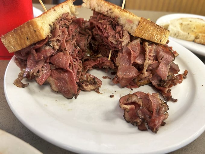 This isn't just a pastrami sandwich; it's a meditation on excess. Notice how the meat has achieved that perfect balance between "generous" and "ridiculous."
