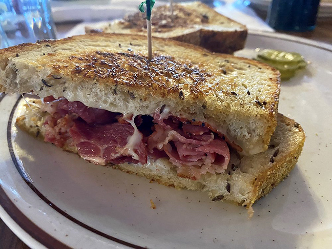 This isn't just a sandwich; it's architecture. Layers of warm pastrami and melted cheese between perfectly grilled rye&mdash;a skyscraper of flavor.