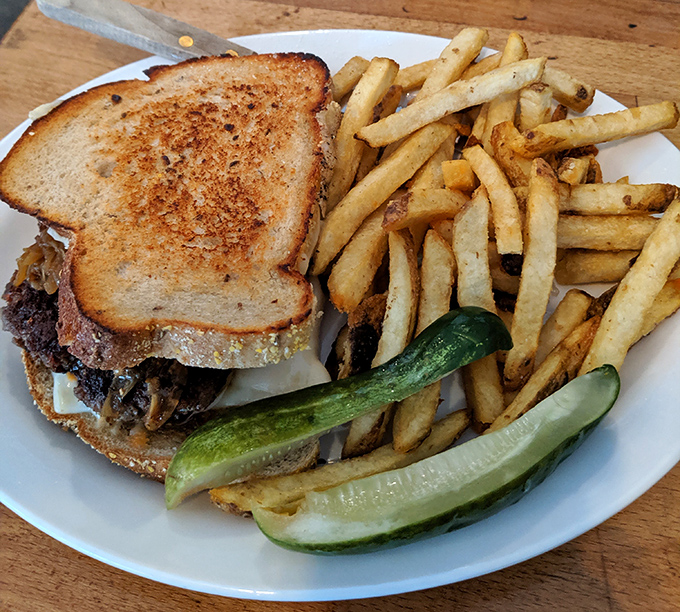 The perfect marriage of toasted rye, melted cheese, and savory meat. Those golden fries aren't just a side—they're mandatory happiness sticks.