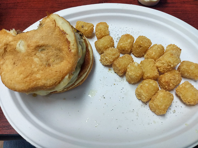 The humble patty melt, paired with golden tater tots, proves that sometimes the simplest pleasures deliver the most satisfaction.