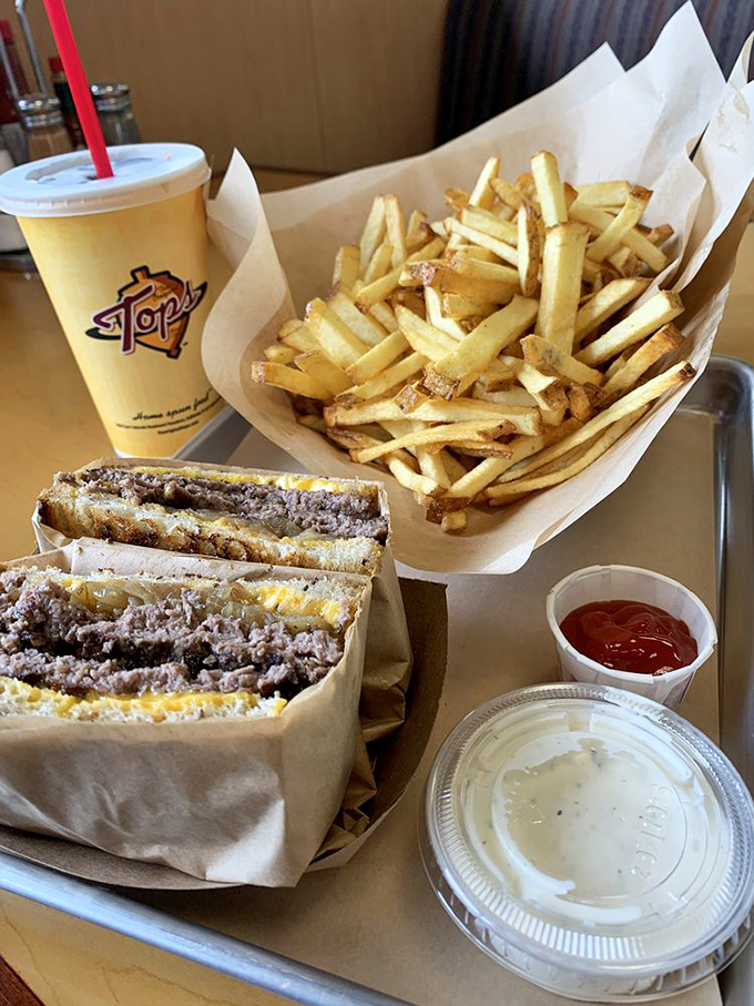 The holy trinity of diner perfection &ndash; golden fries, a hearty sandwich, and that signature yellow cup. Comfort food, assemble!