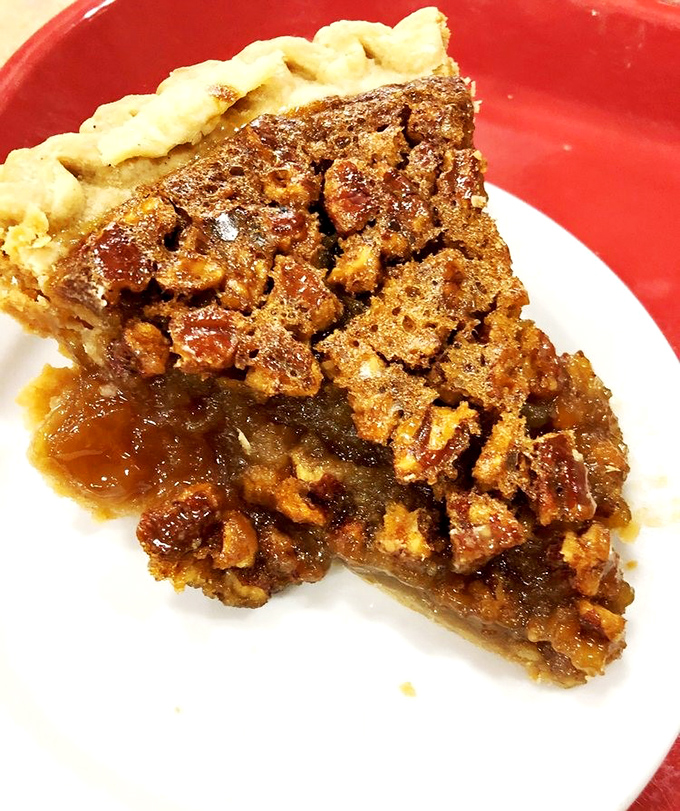 This pecan pie slice could negotiate peace treaties with its perfect balance of nuts and sweetness.