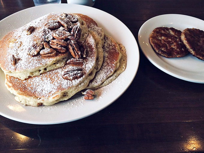 Pecan pancakes that make you question every other breakfast decision you've ever made. The side of sausage patties is just playing a supporting role.