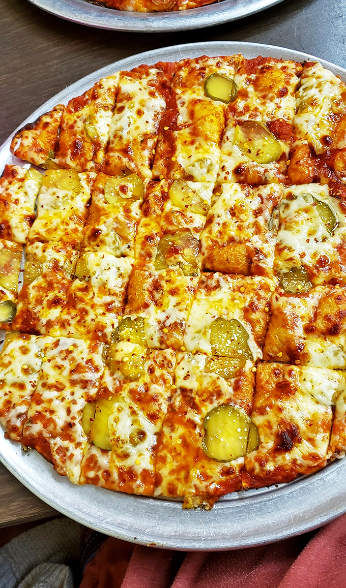 Pickle pizza might sound like a dare, but those bright green discs bring a tangy crunch that makes perfect sense after the first bite.