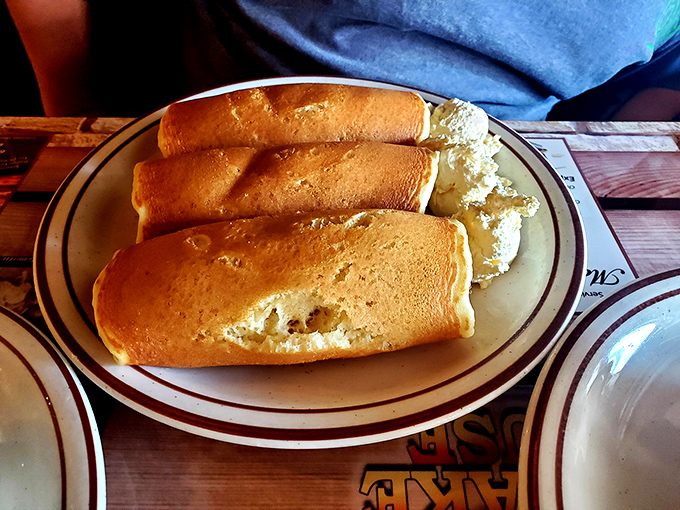 These aren't your average pigs in blankets—they're the aristocracy of breakfast sausages, wrapped in pancake royalty and ready for their syrup bath.