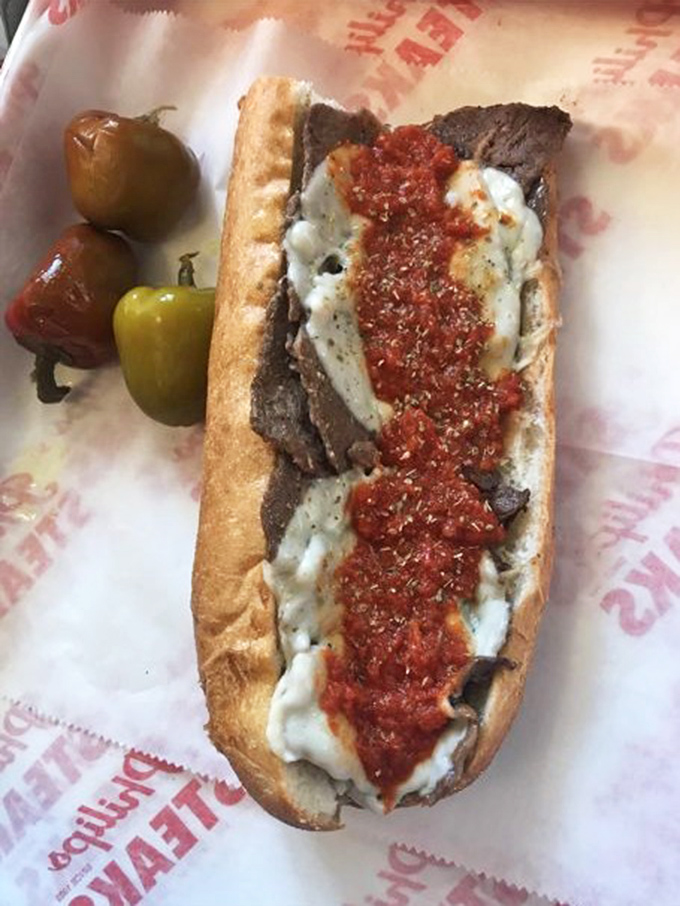 The pizza steak&mdash;where two Philly classics collide in holy matrimony. Those peppers on the side aren't just garnish; they're flavor grenades waiting to deploy.