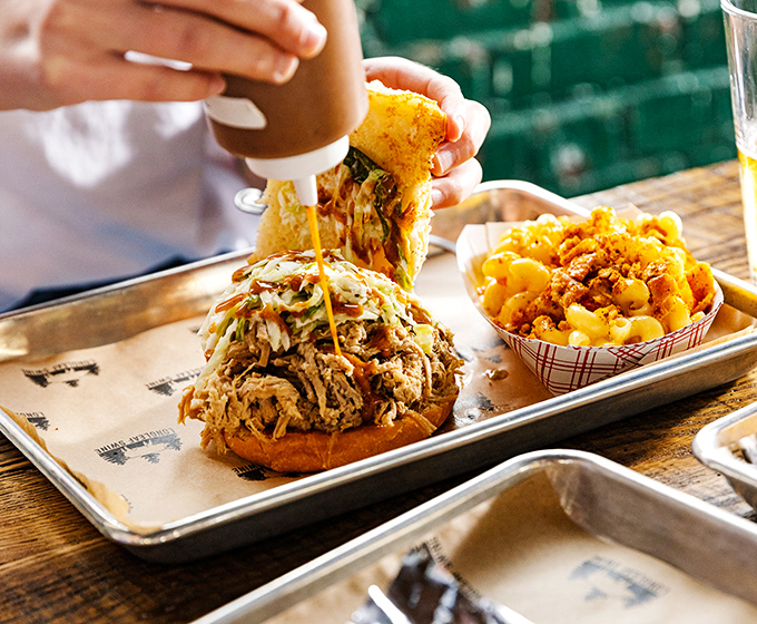 The pulled pork sandwich &ndash; an architectural marvel where smoke-kissed meat meets pillowy bun in a relationship that was clearly meant to be.