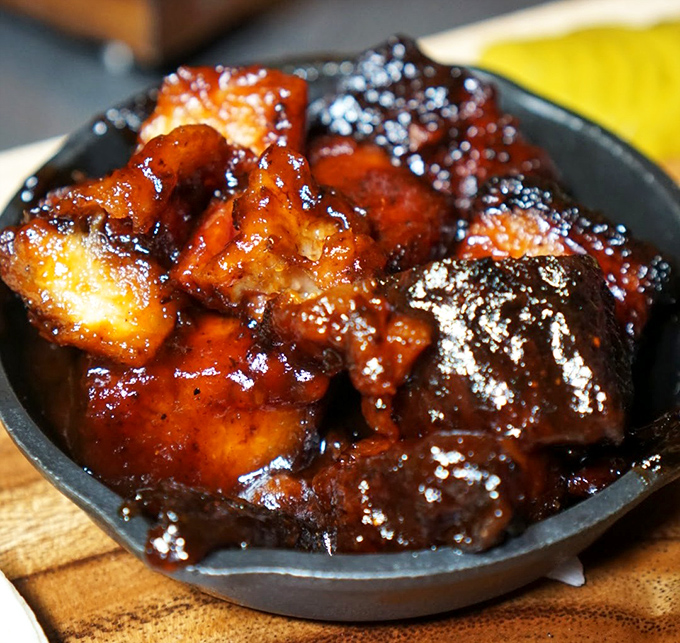 Pork belly burnt ends glistening with sticky-sweet sauce. These caramelized meat candy cubes are what barbecue dreams are made of.