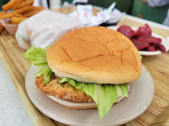 The pork tenderloin sandwich—an Indiana tradition that crossed the border into Ohio. When the meat extends beyond the bun like that, you know you're in good hands.
