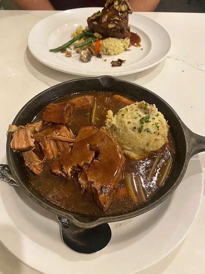 Pot roast so tender it surrenders at the mere suggestion of your fork, swimming in a gravy that deserves its own fan club.