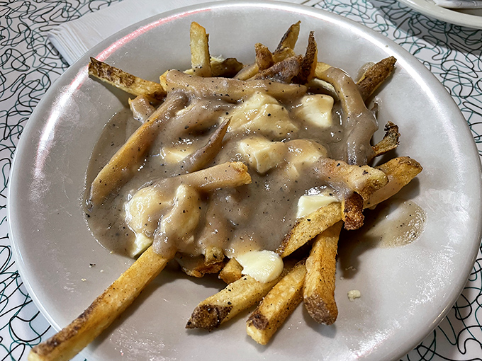 Gravy-drenched fries with melty cheese curds&mdash;proof that sometimes the messiest foods deliver the most direct route to happiness.