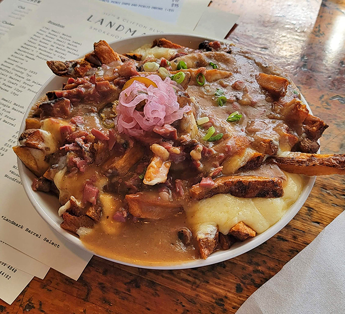 Poutine gets the barbecue treatment with smoky meat, melty cheese, and pickled onions. Like Canada and the American South had a delicious culinary love child.