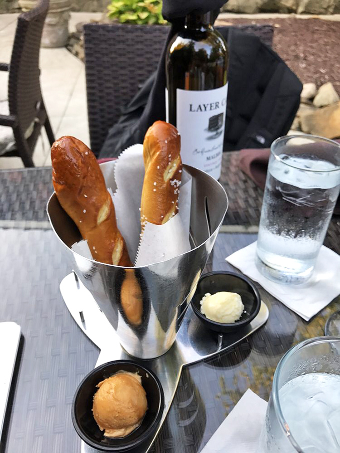 Pretzel breadsticks standing at attention like delicious sentinels guarding their dipping companions. Carbs have never looked more worthy of breaking your diet.