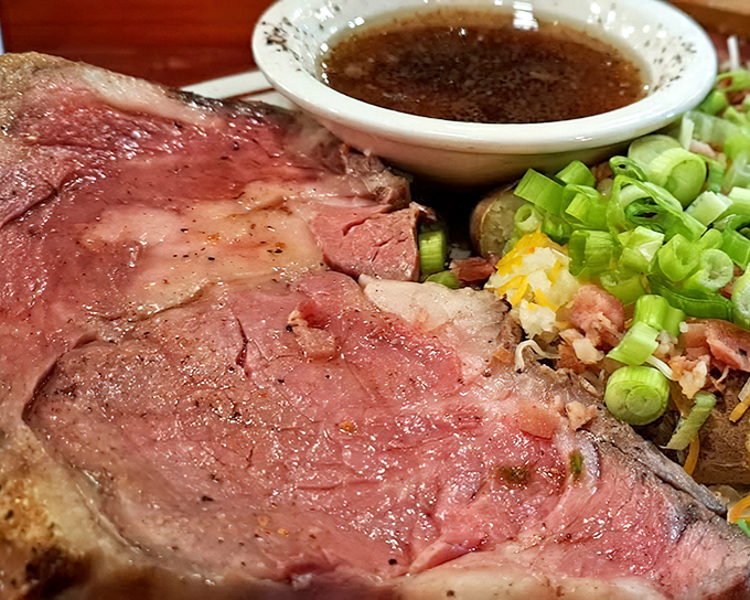 Behold the prime rib in all its rosy glory, accompanied by a loaded potato. This is what meat dreams are made of, folks.