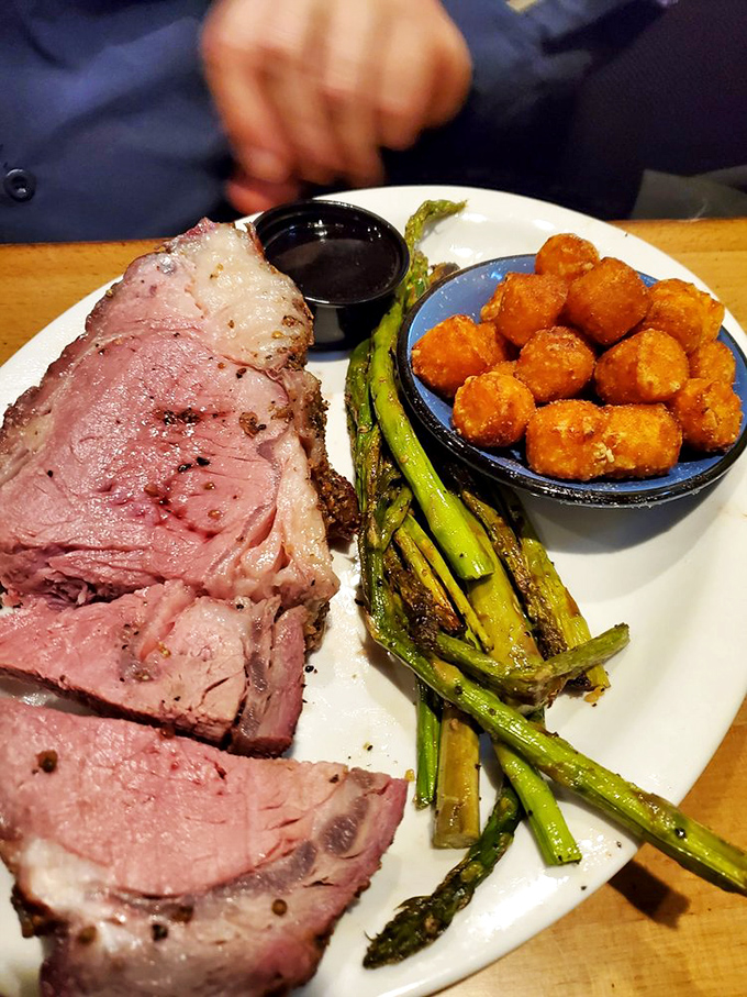 Prime rib that's blushing pink in all the right places, paired with asparagus and sweet potato tots that could make a vegetarian question their life choices.