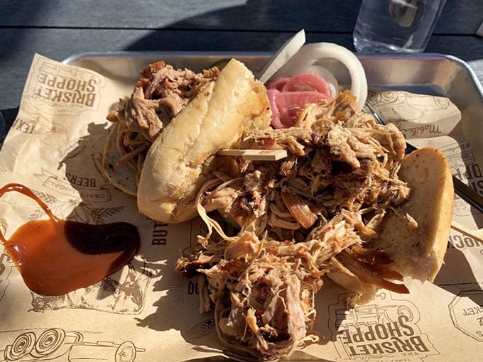 A pulled pork sandwich so generous it requires strategic planning &ndash; where to start, how to hold it, and whether to share (don't).
