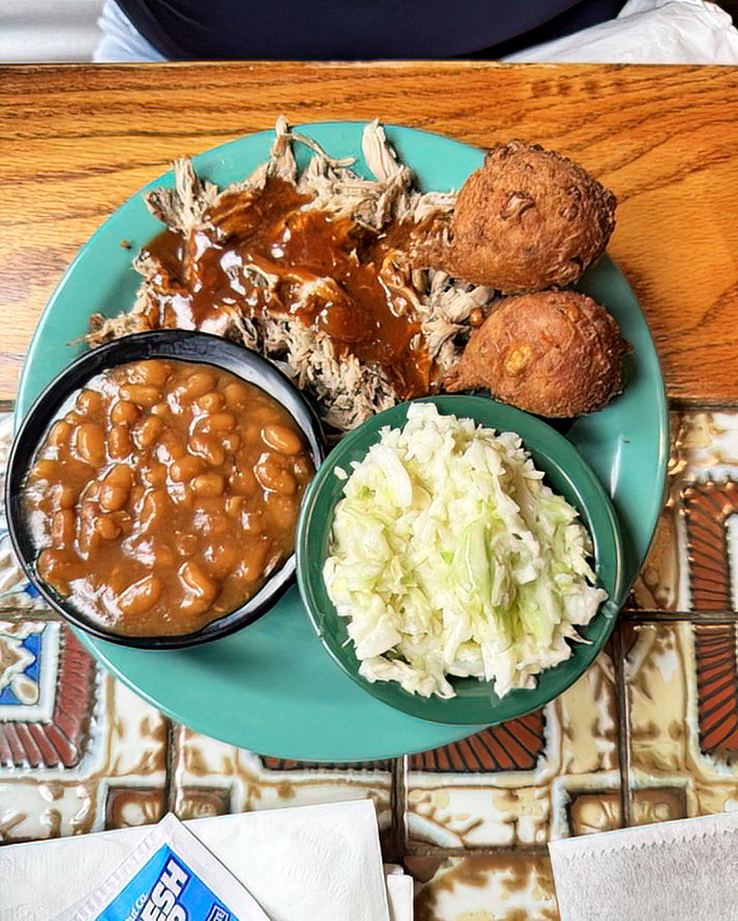Pulled pork so tender it practically shredded itself, paired with classic Southern sides. This plate doesn't need Instagram filters to look irresistible.