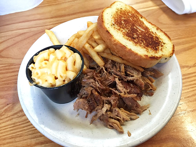 Pulled pork that's spent hours contemplating its existence in the smoker, served with mac and cheese that's unapologetically comfort-food perfect.