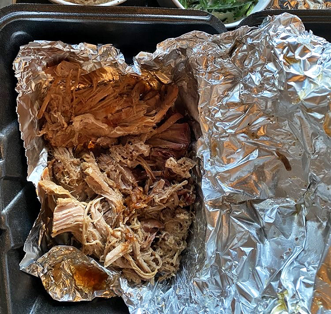 Pulled pork nestled in foil like a precious metal, which in the barbecue world, it absolutely is.