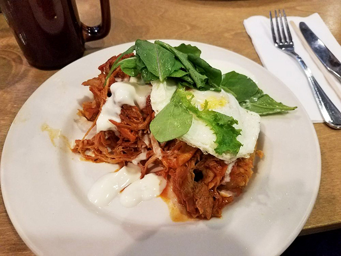 Pulled pork hash topped with a perfect egg and fresh greens. Breakfast doesn't get more satisfying than this savory symphony.