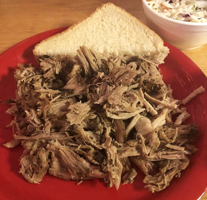 Pulled pork that looks like it surrendered to gravity after a long, smoky meditation. That heap of tender strands is what barbecue dreams are made of.