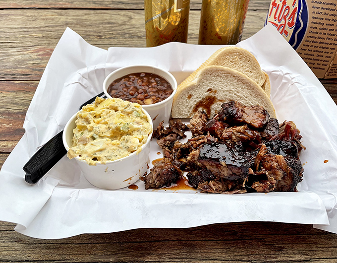 A barbecue tray that speaks the universal language of comfort&mdash;smoky meat, potato salad, and beans, with bread standing by to soak up every precious drop.