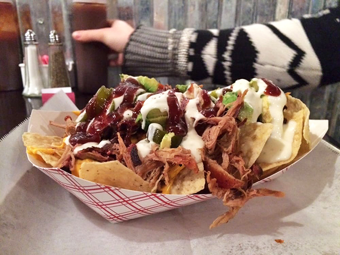 These loaded nachos aren't just a meal&mdash;they're an architectural achievement of pulled pork, sauce, and toppings that somehow maintains structural integrity.
