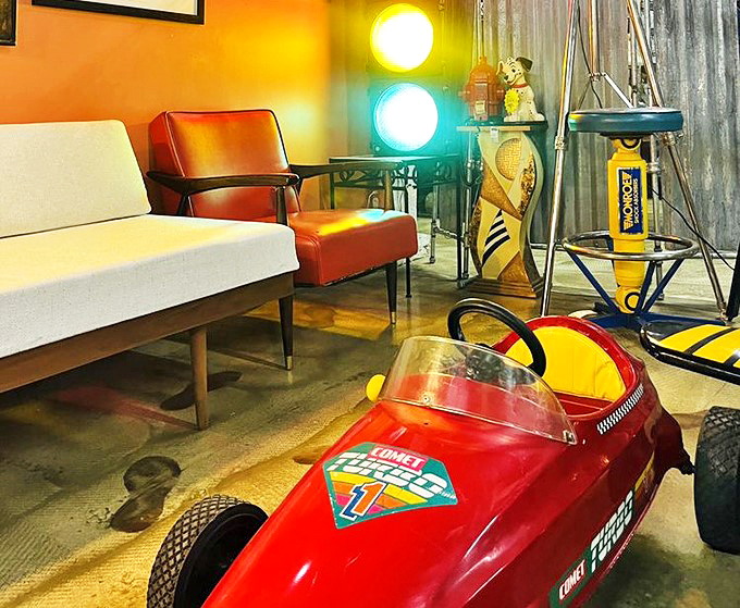 This retro living room setup with its cherry-red racing car would make Don Draper jealous of your time-traveling decorating skills.