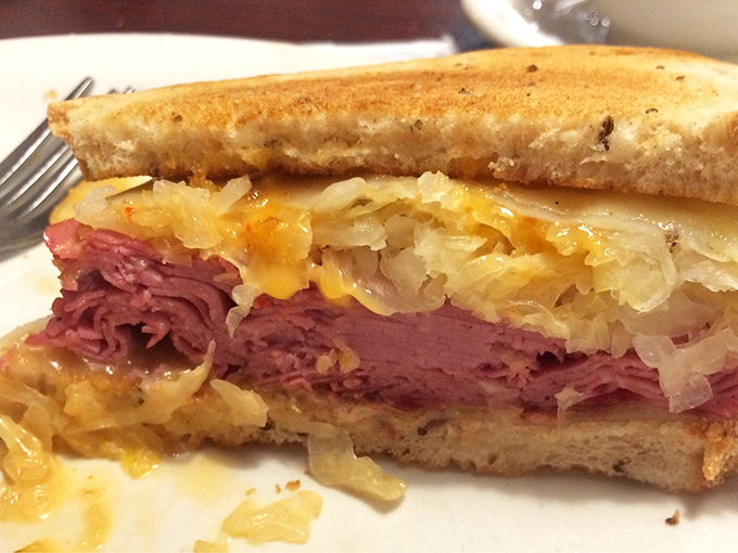 This Reuben isn't just a sandwich; it's an engineering marvel of corned beef, sauerkraut, and melted Swiss that demands a strategic eating plan.