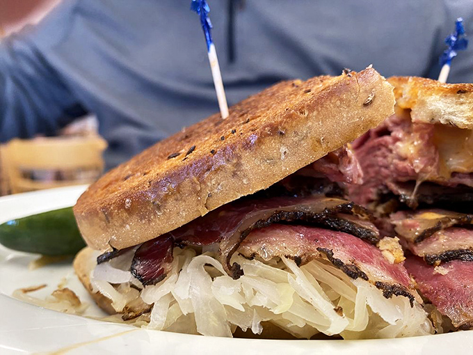 The holy trinity of deli greatness: properly marbled meat, tangy sauerkraut, and rye bread with character. This isn't a sandwich – it's architecture.