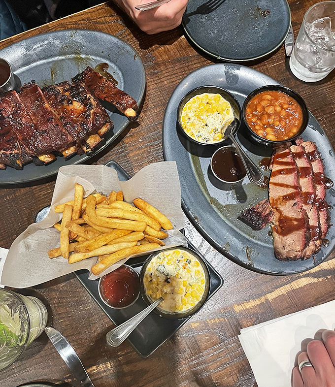 The holy trinity of Kansas City barbecue: ribs, brisket, and beans creating pure carnivorous harmony together.
