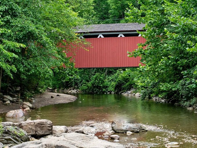From this angle, the bridge appears to float above the water like a rustic mirage, its reflection dancing in the gentle current below.