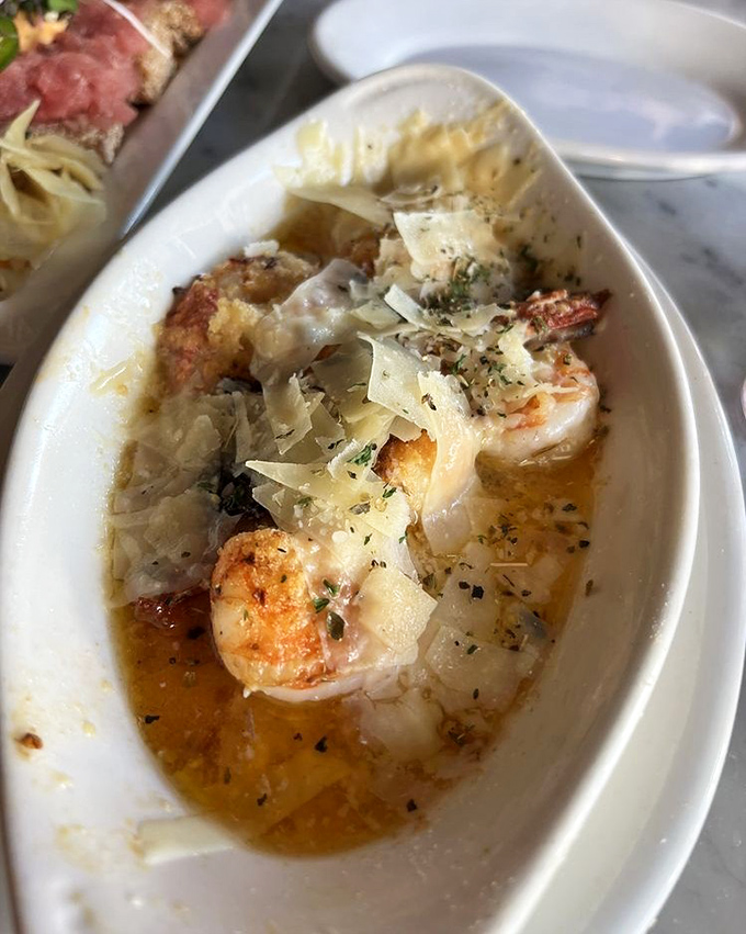Plump shrimp basking in garlic butter with shaved parmesan&mdash;proof that sometimes the simplest combinations create the most profound happiness.