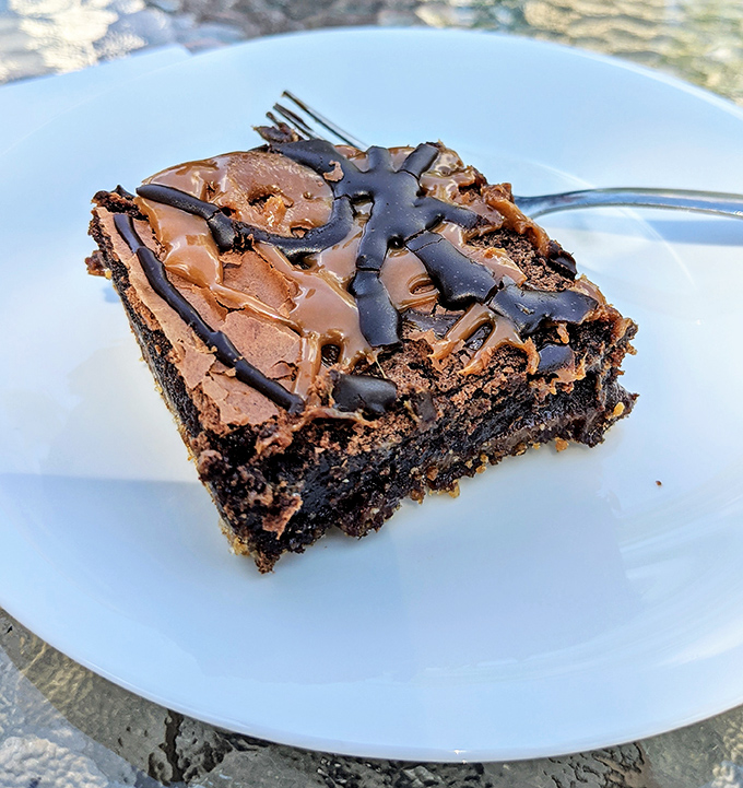 A brownie so decadent it should require a permission slip. The salt-caramel drizzle is the culinary equivalent of a standing ovation.