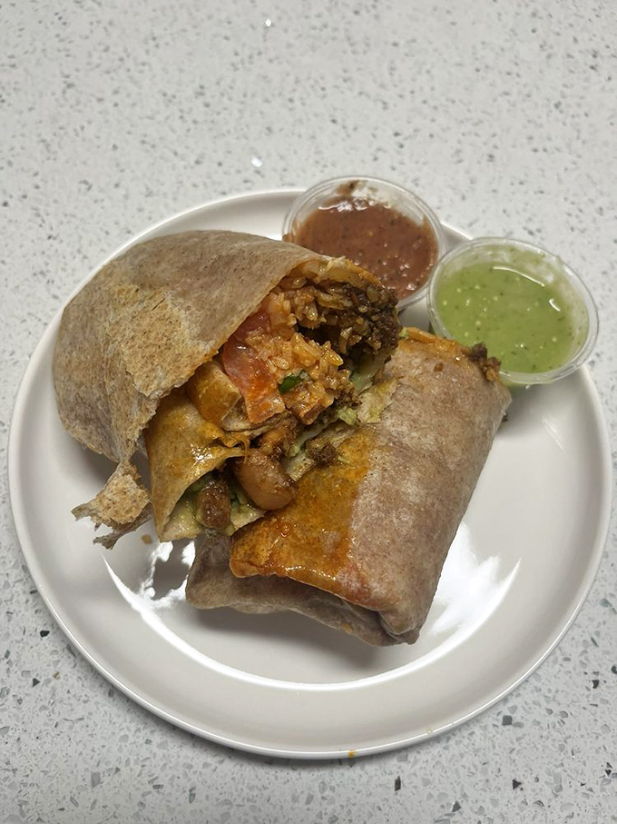 Behold the San Francisco burrito in its natural habitat—a foil-wrapped flavor bomb that requires both hands and zero inhibitions.