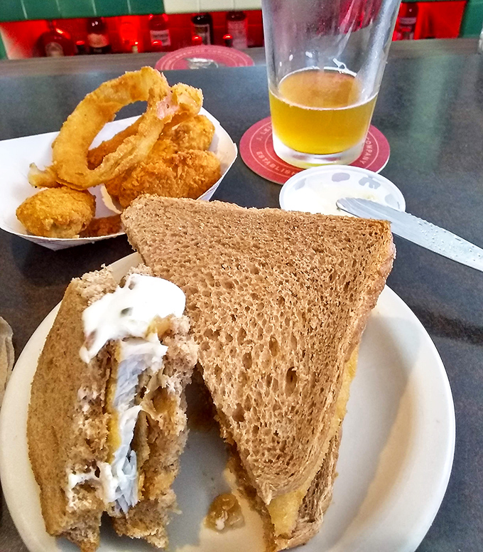 This sandwich isn't just lunch; it's a Midwest tradition on wheat bread with a side of golden onion rings and a cold beer. Pure Wisconsin bliss.