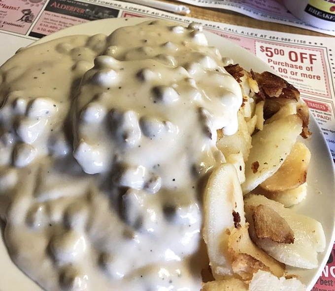 Gravy so good it deserves its own zip code. This creamy blanket of comfort covering home fries is what breakfast dreams are made of.