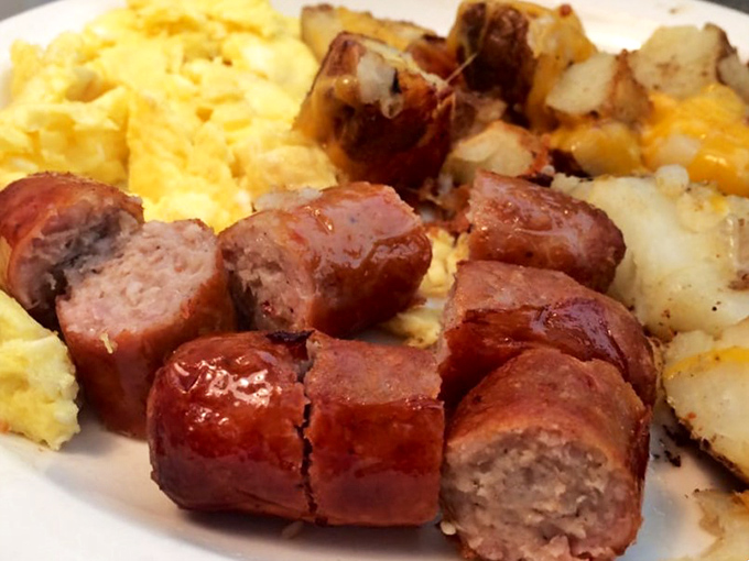 Sausage links that snap with each bite, nestled beside eggs and potatoes like the breakfast trinity that's been saving mornings since time began.