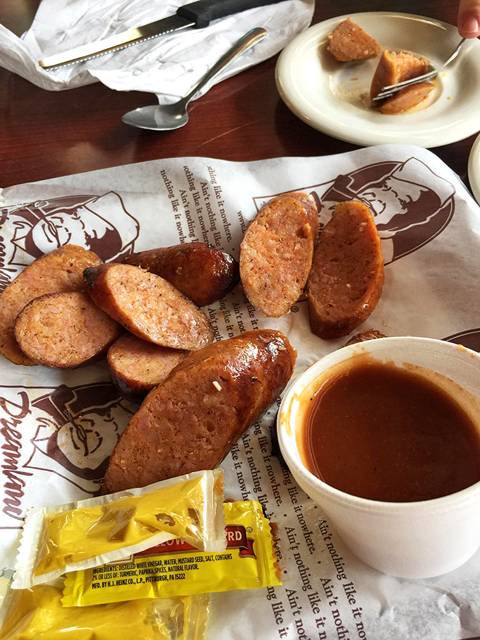 Sausage links glistening with promise, sliced and ready for their sauce bath. Meat candy for grown-ups who know what matters.