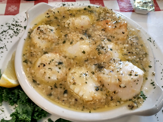 These scallops swim in buttery, herb-flecked glory &ndash; proof that simple preparations often yield the most sublime results when quality ingredients take center stage.