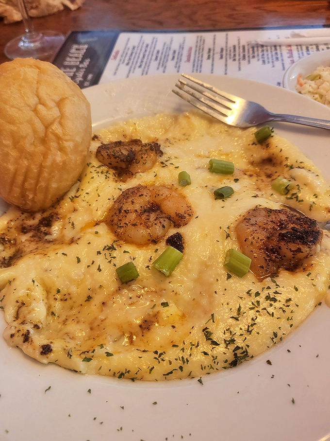 Blackened scallops nestled in creamy heaven with a side of buttery biscuit. This dish doesn't just speak to you—it writes love sonnets.