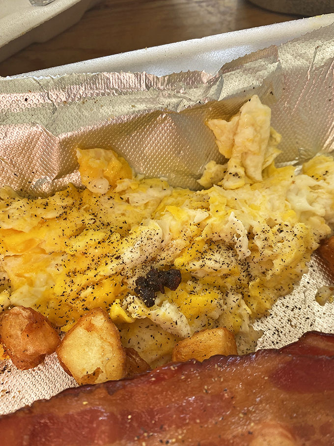 Scrambled eggs nestled in foil like precious cargo, because sometimes the simplest things deserve the fanciest treatment.