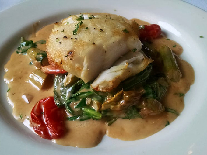 Sea bass that looks like it's swimming in flavor. The delicate fish practically floats in a sauce worthy of being sopped up with every available bread morsel.