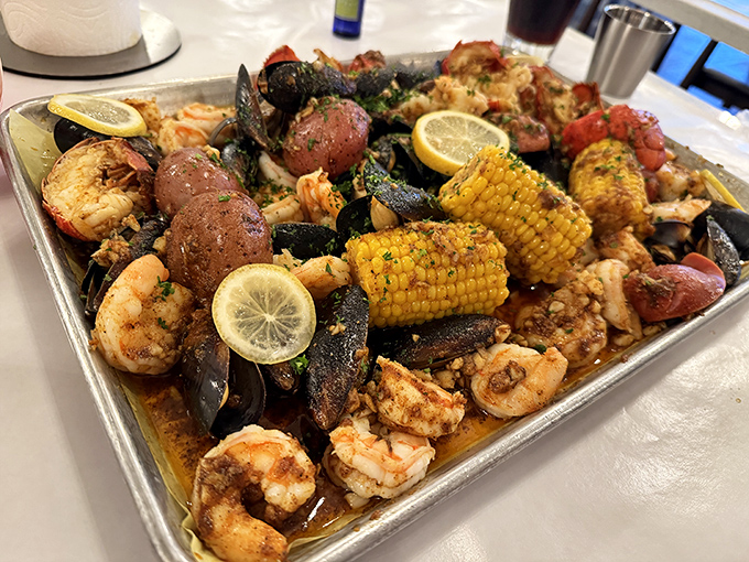 A seafood boil that's essentially a treasure chest—mussels, shrimp, corn, potatoes, and sausage swimming in seasoned butter that demands to be sopped up.