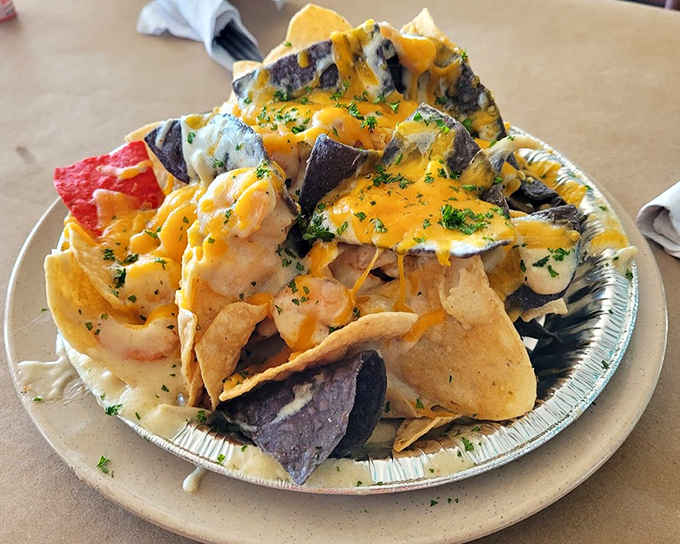 Seafood nachos that break all the rules in the best possible way. Whoever thought of putting seafood on chips deserves a Nobel Prize.