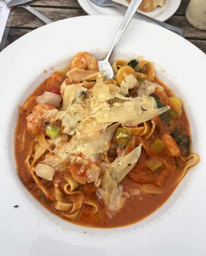 Pasta swimming in a sea of shrimp and rich tomato sauce. Each forkful delivers a taste of coastal comfort that warms you from the inside out.